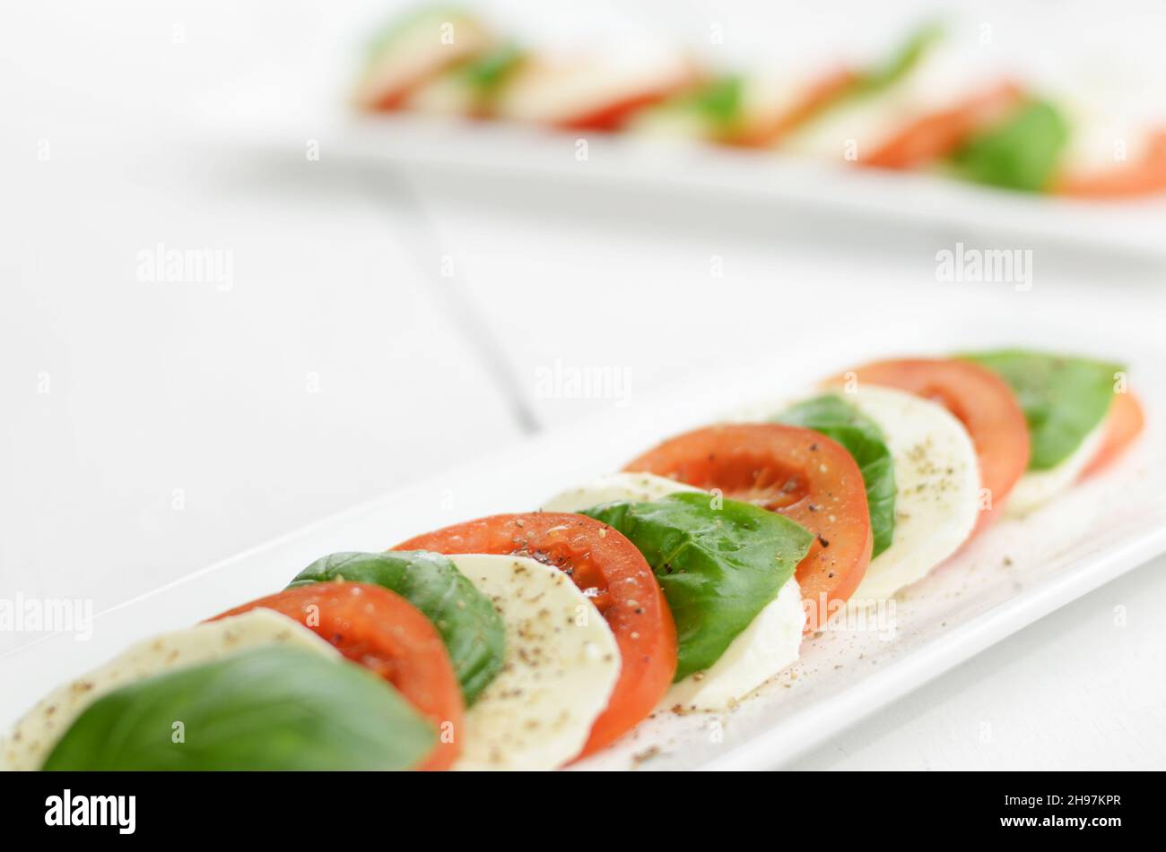 Classic caprese - mozzarella tomatoes and basil Stock Photo - Alamy