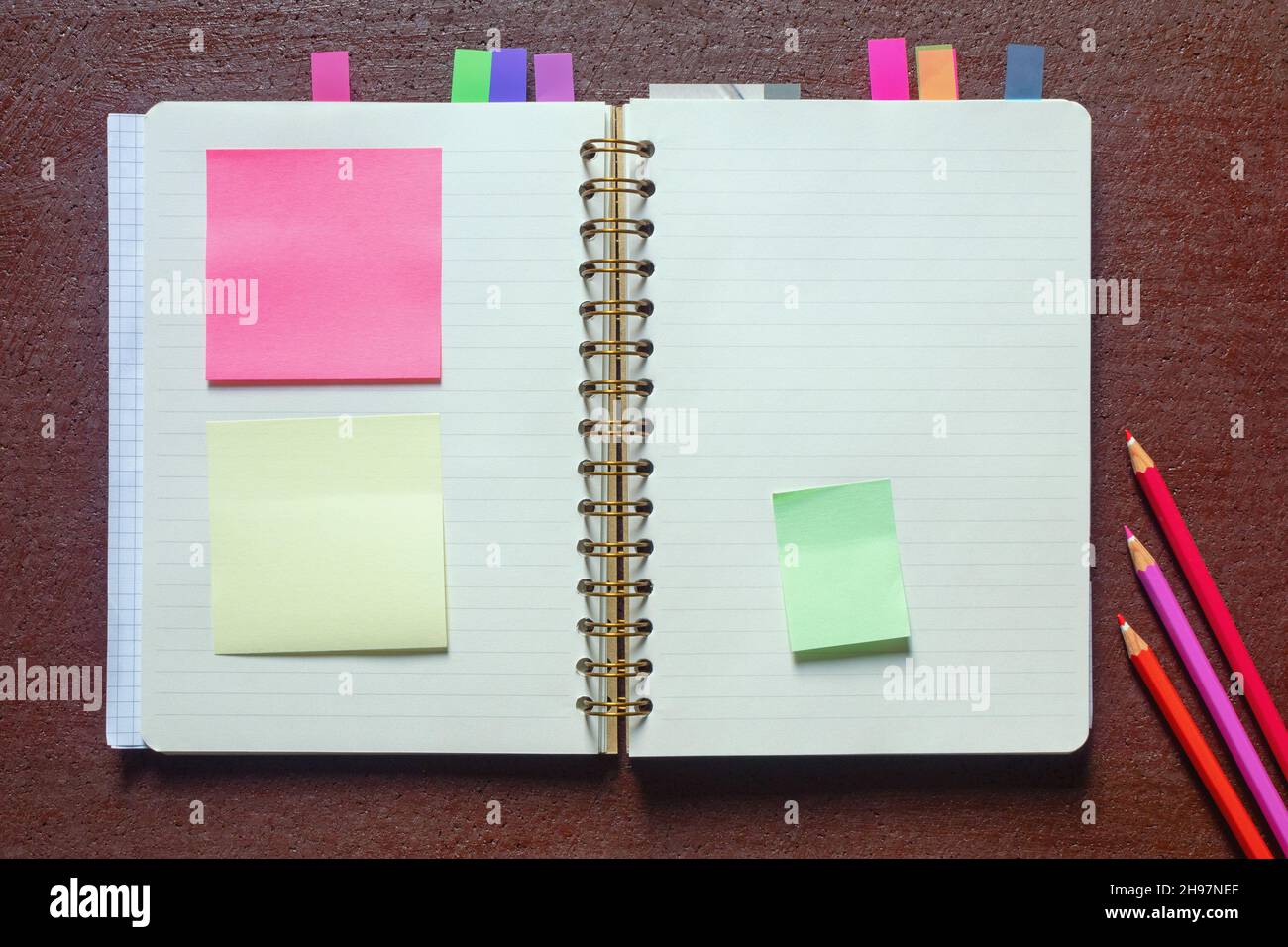 Open spiral bound notebook with blank pages and post-it notes. Flat lay ...