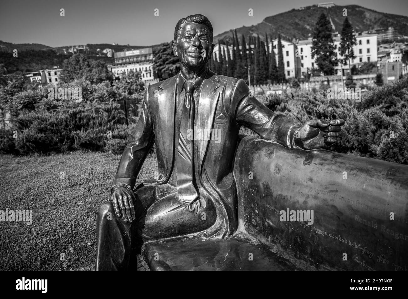 Bronze statue of Ronald Reagan sitting on a bench in Rike Park. Tbilisi ...