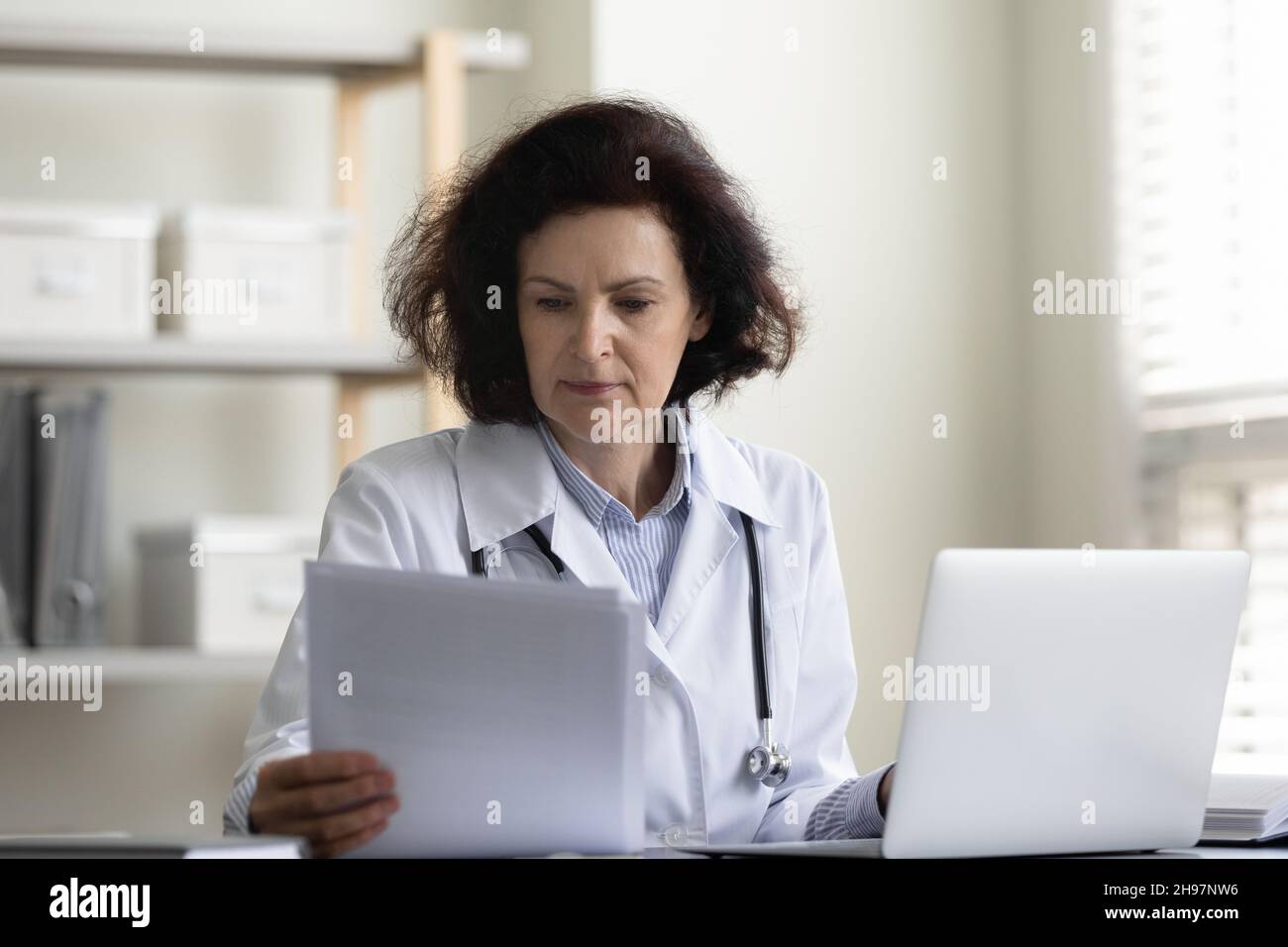 Focused woman reading record hi-res stock photography and images - Alamy