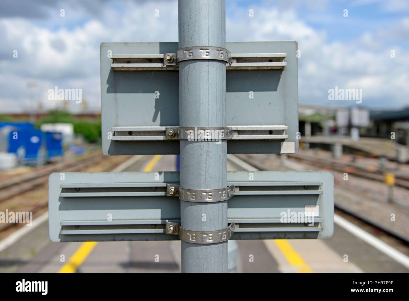 Signs attached to a pole at the end of a platform at a railway station ...