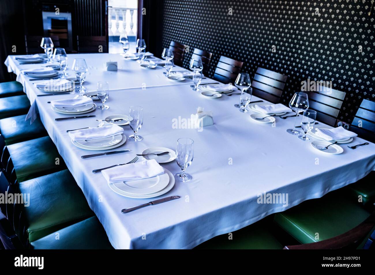 Big table at restaurant served for upcoming banquet Stock Photo - Alamy