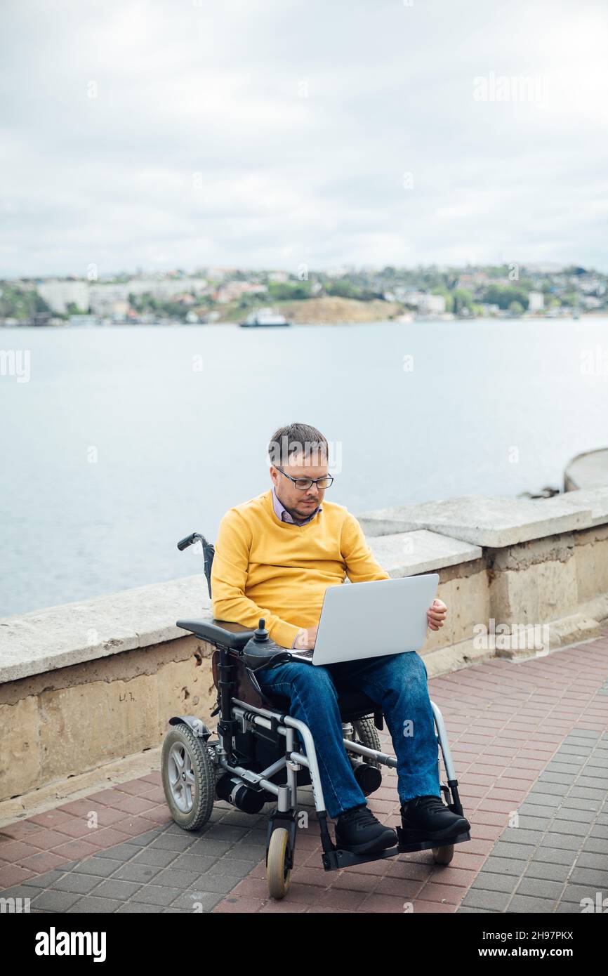 a man with a disability in a disabled working business remotely Stock ...