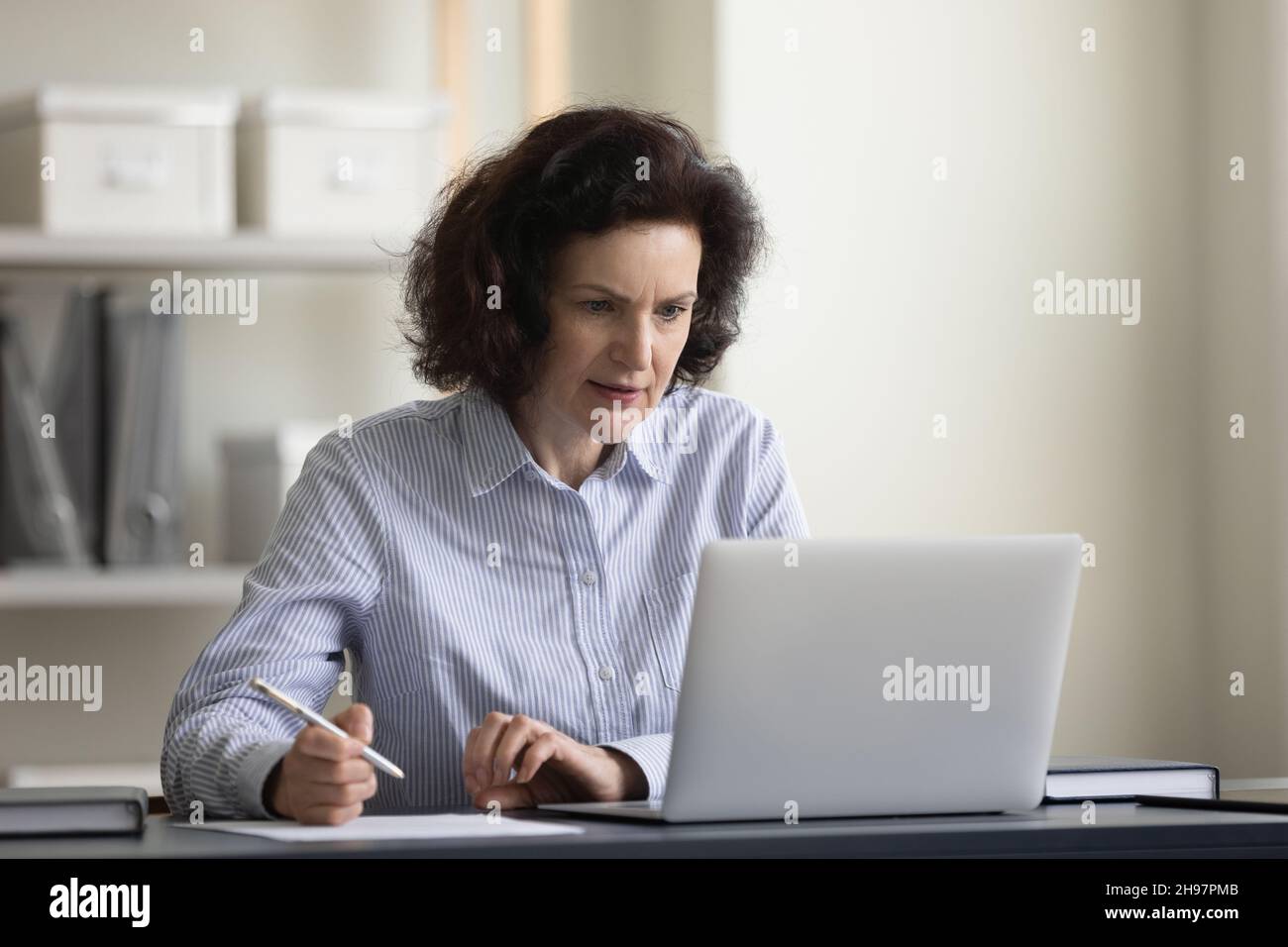 Serious elderly businesswoman focused hi-res stock photography and ...