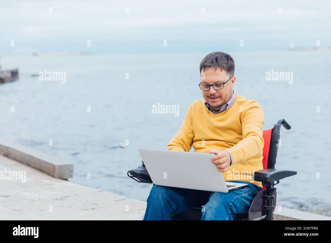a man with a disability in a disabled working business remotely Stock ...
