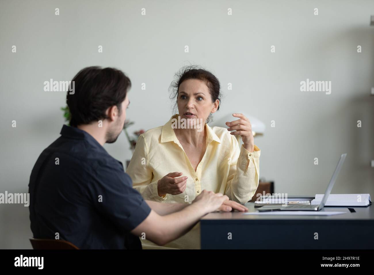 Mature female customer and insurance agent meeting at workplace Stock ...