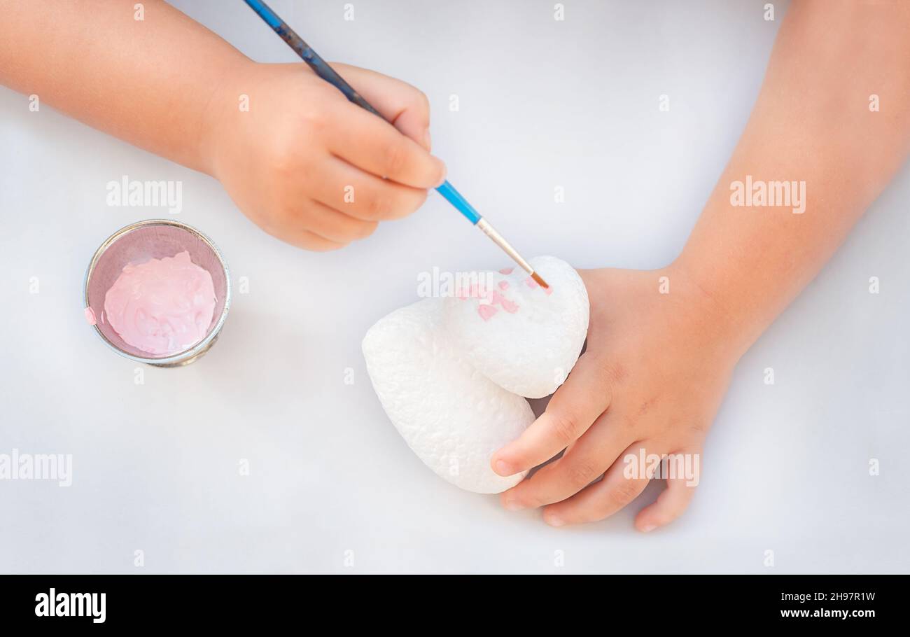 child hands paint the heart with pink paint and a brush Stock Photo - Alamy