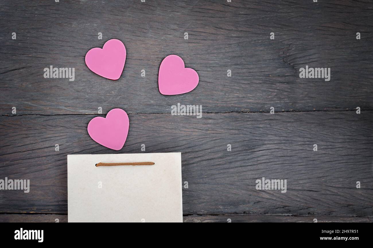hearts and paper bag. pink three hearts and cardboard pack Stock Photo ...