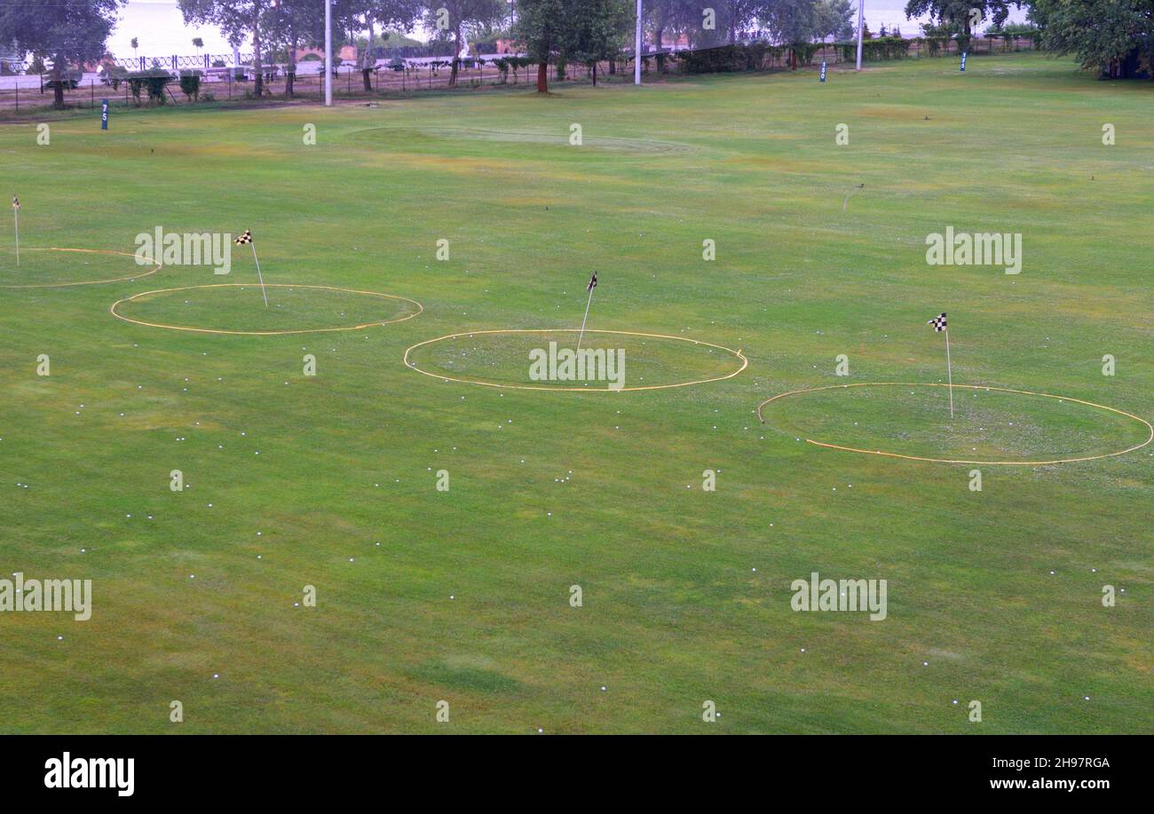 Outdoor green grass golf course with scenic of trees and riverside ...