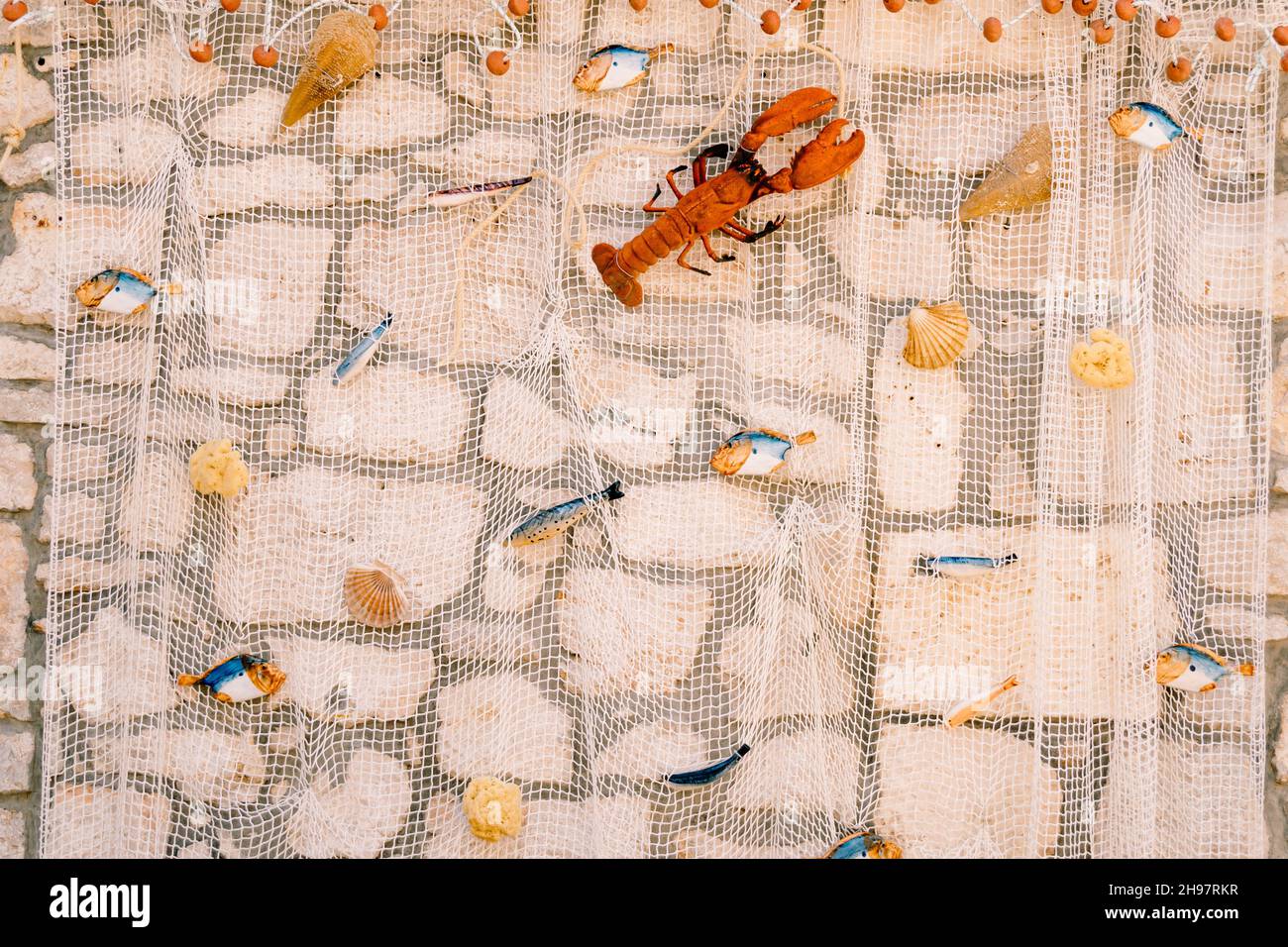 Small fish, shells and crayfish are attached as bait to a fishing net ...