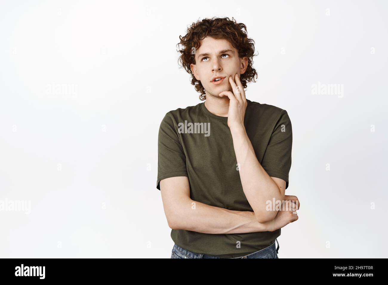 Bored funny male model, sighing and roll eyes annoyed, standing in ...