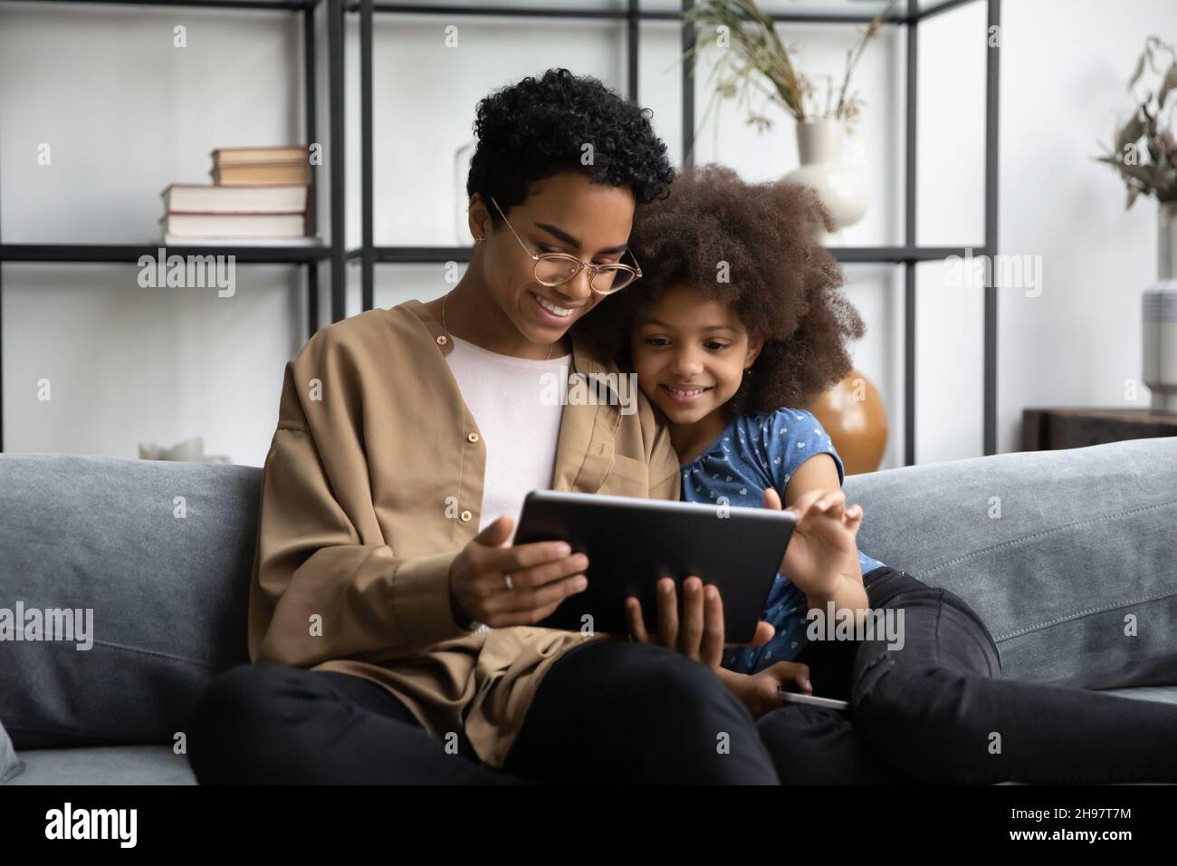 Happy African American family using digital computer tablet Stock Photo ...