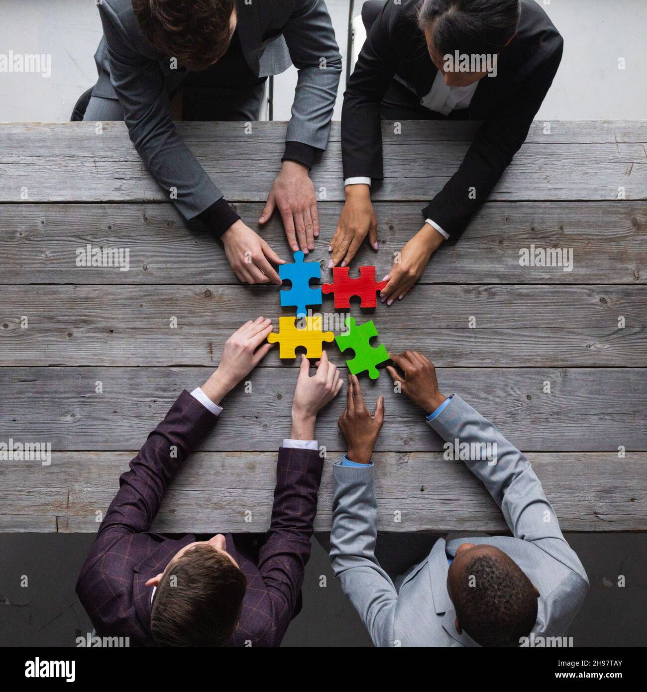 Group of business people assembling jigsaw puzzle, team support problem ...