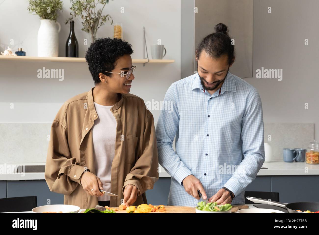 Happy African American couple cooking in kitchen Stock Photo - Alamy