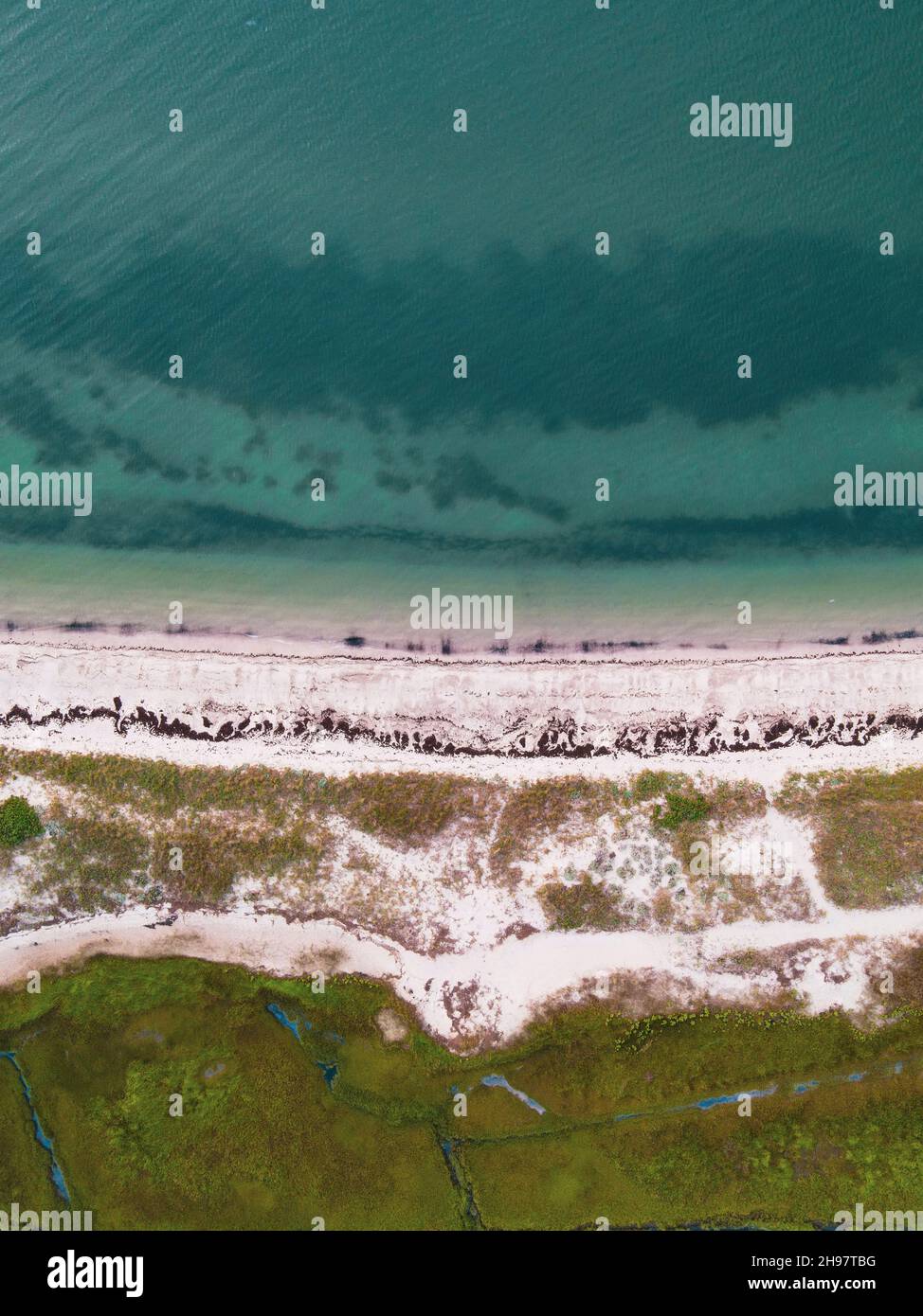 A bird's eye view of a sandy shore with lagoon water Stock Photo - Alamy