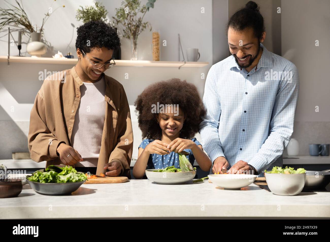 Joyful African American family cooking in kitchen Stock Photo - Alamy