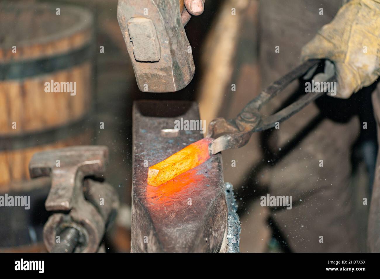 Blacksmith working metal with hammer on the anvil in the forge Stock ...