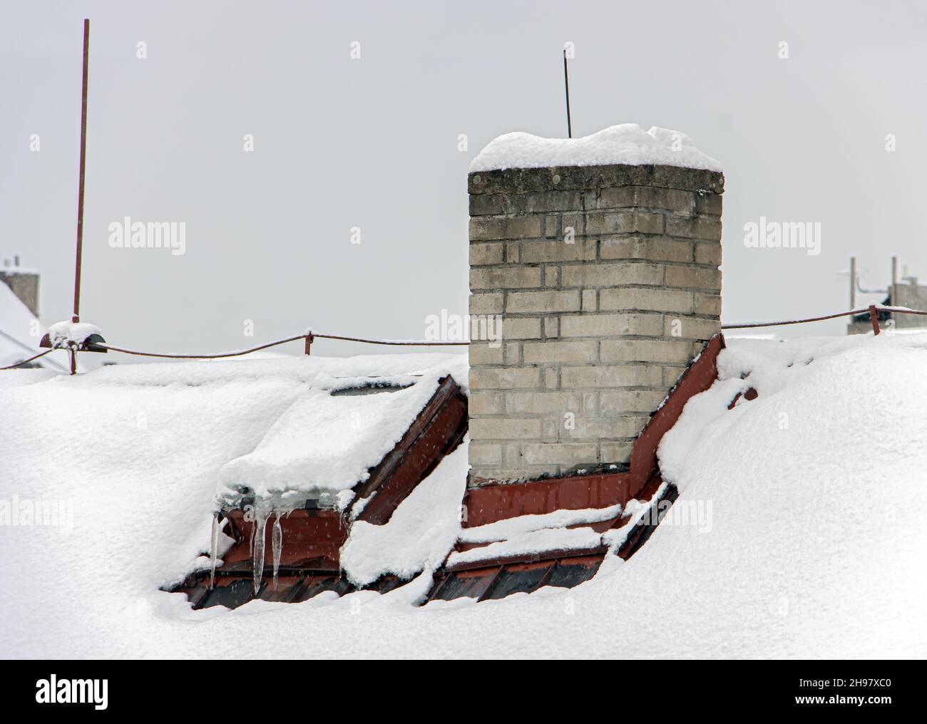 Snow covered roof of house with chimney and skylight Stock Photo - Alamy