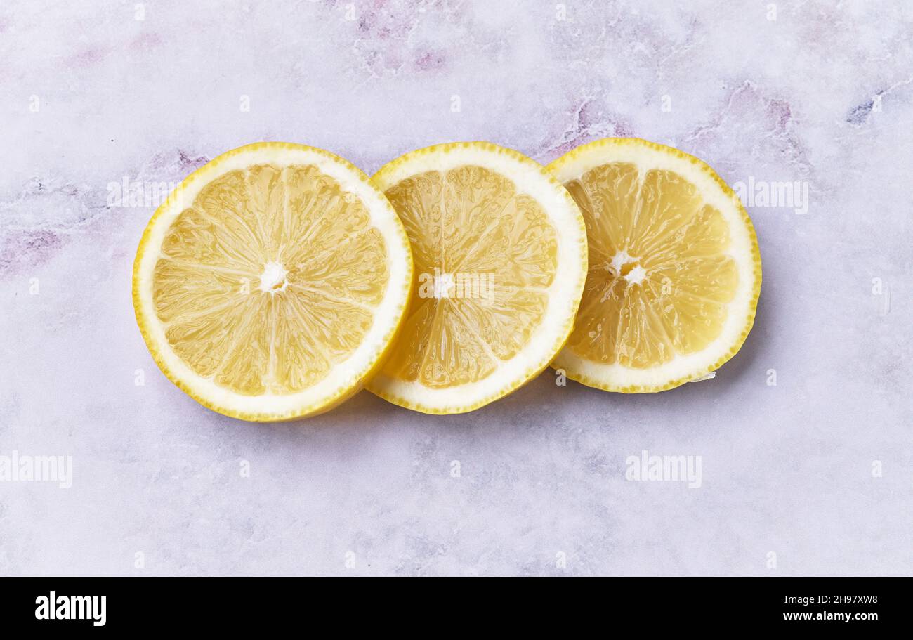 Slices of lemon on a marble surface Stock Photo - Alamy