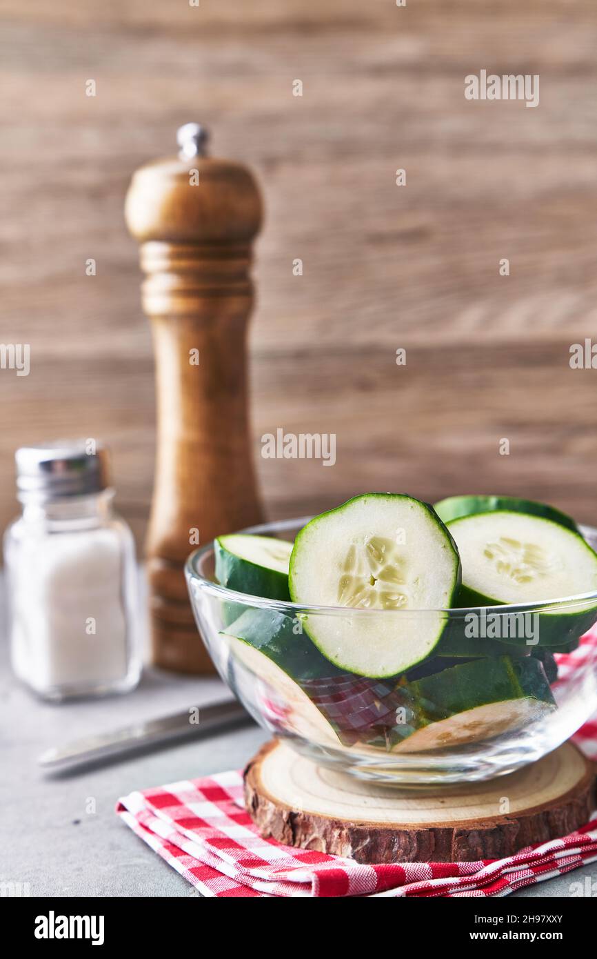 Bowl of slices of cucumber on a marble surface Stock Photo - Alamy