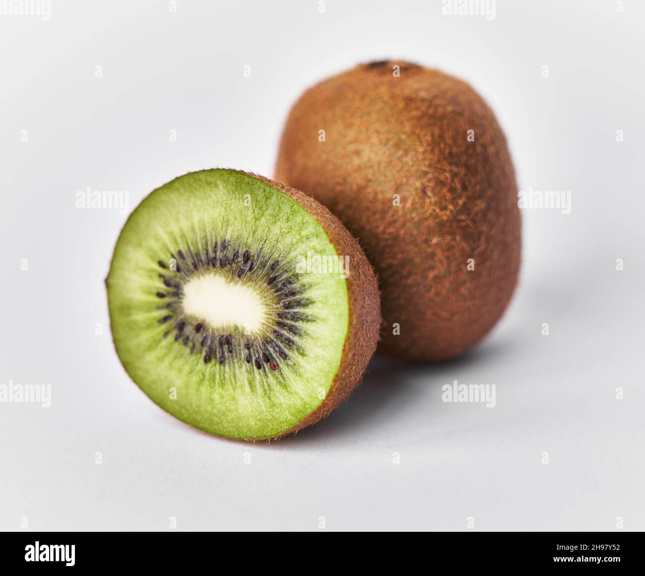 Single kiwi and slice isolated on a white background Stock Photo - Alamy