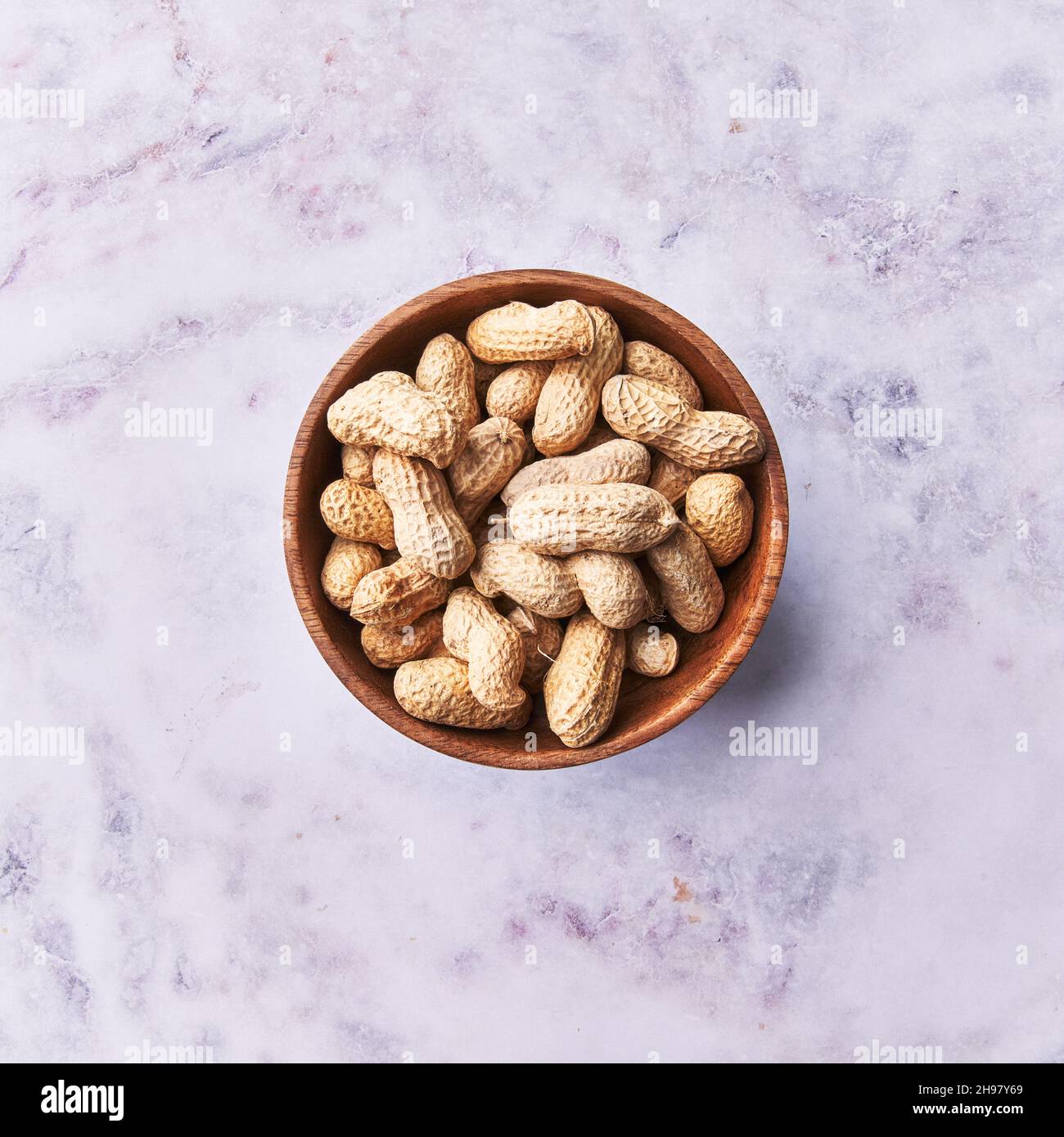 Bowl of peanuts with shell on a marble surface Stock Photo - Alamy