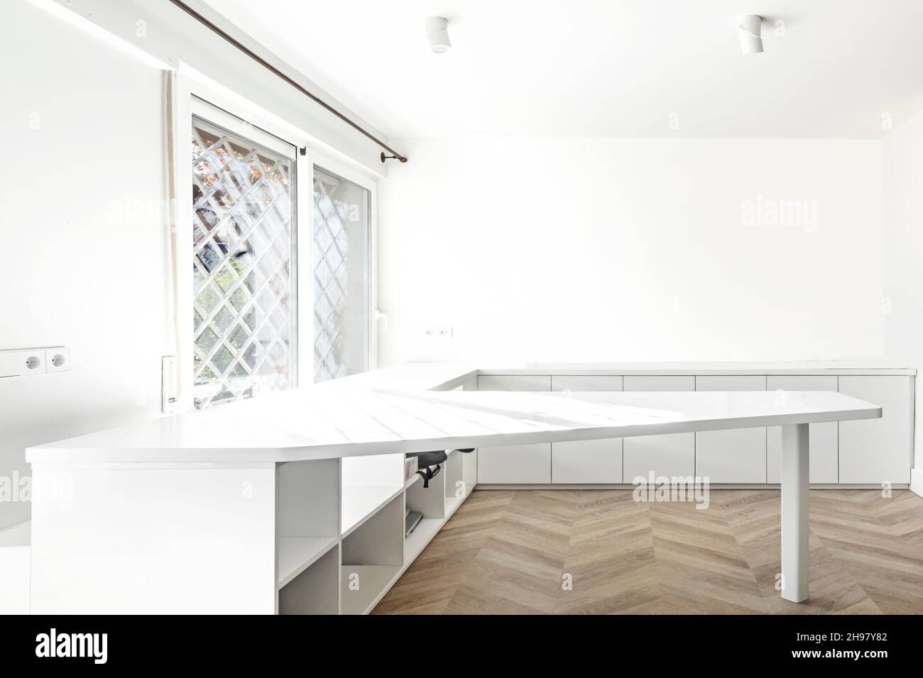 Office table with white wing next to the window Stock Photo - Alamy
