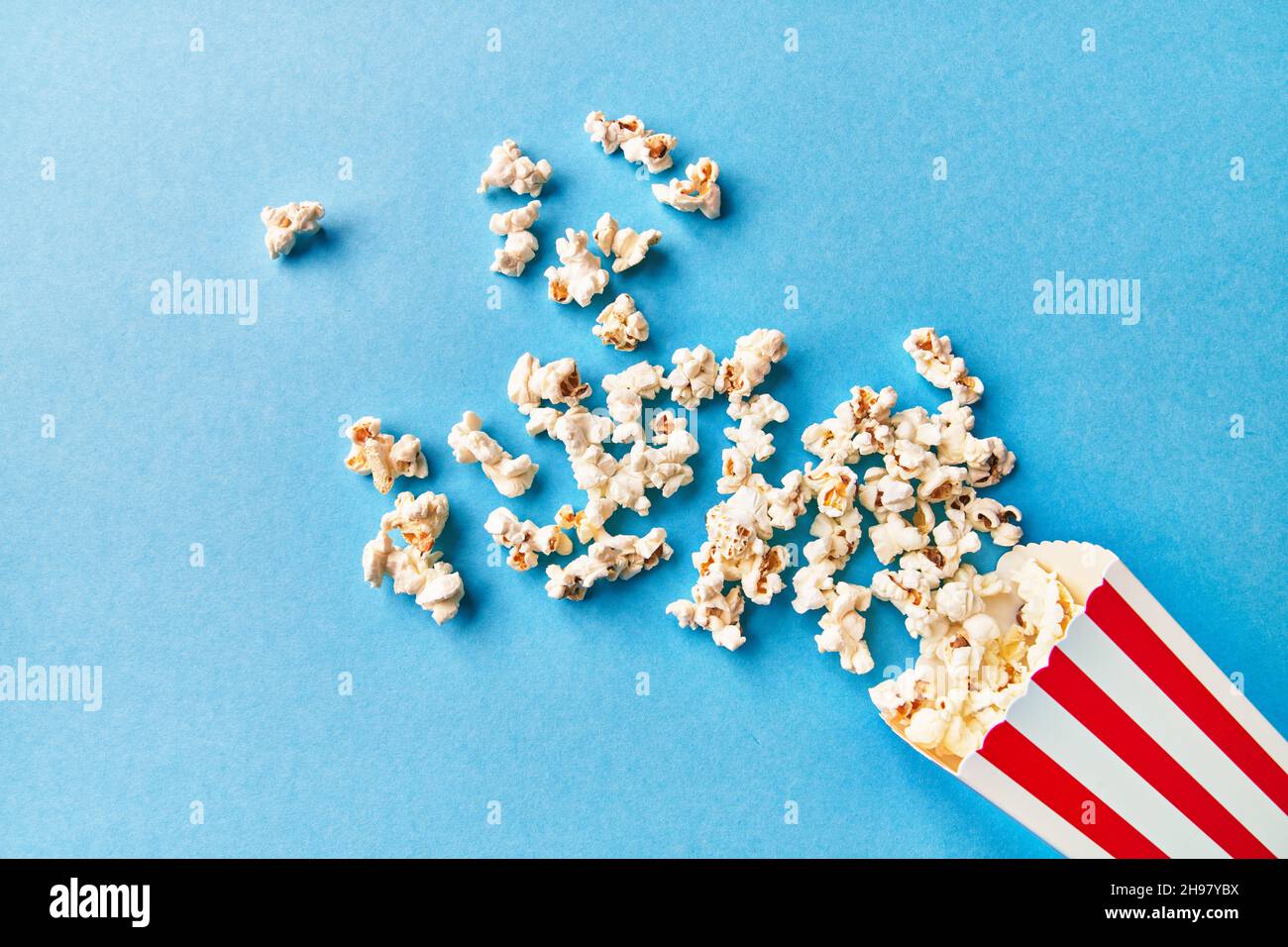 Popcorn falling on blue background hi-res stock photography and images ...