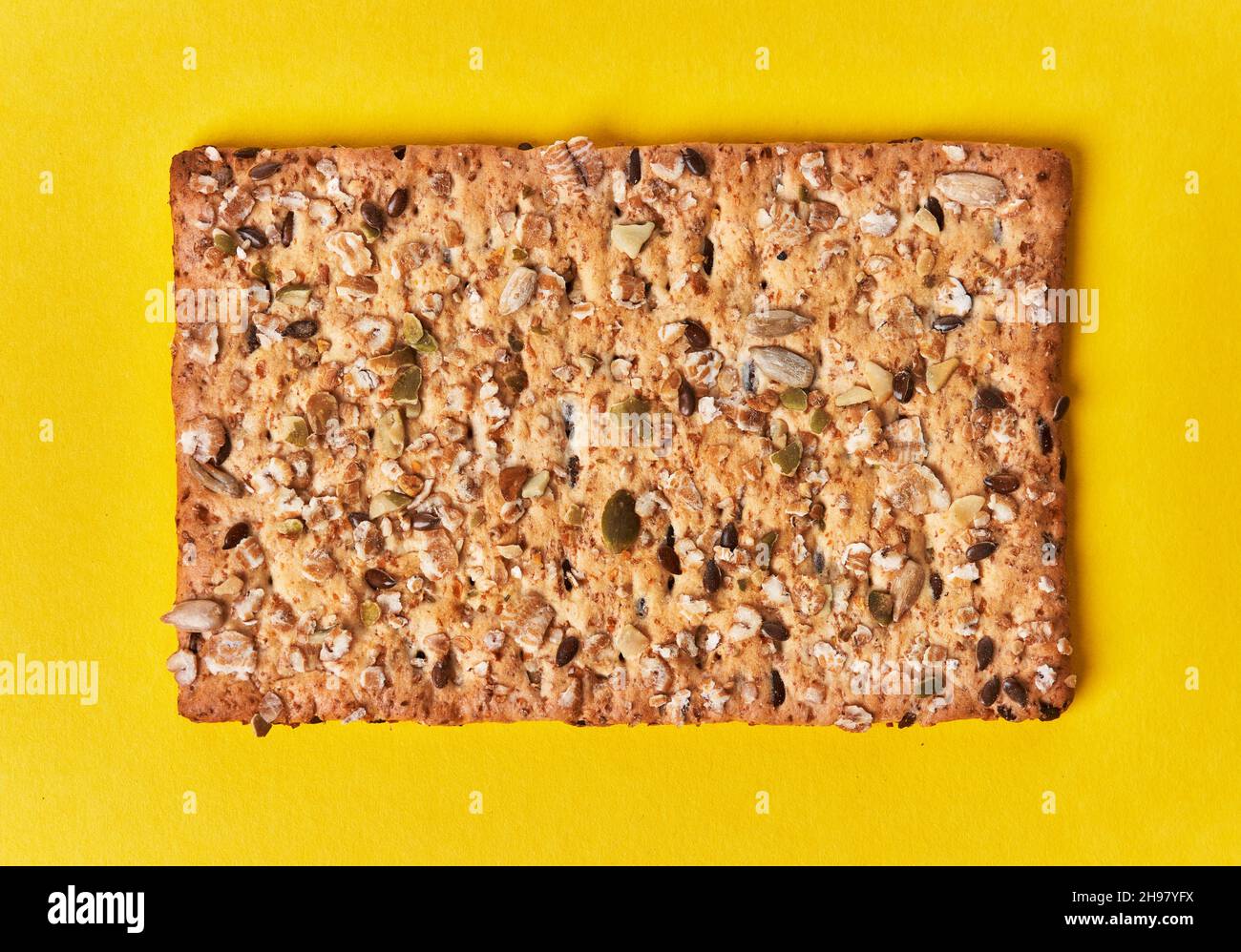 Delicious cereal crunchy cracker on a yellow background Stock Photo - Alamy