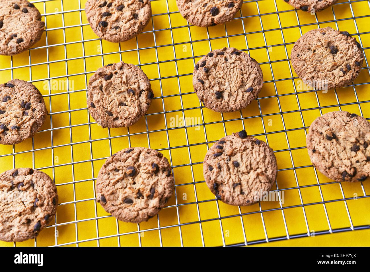Chocolate cookies served on a grid rack on a yellow background Stock ...