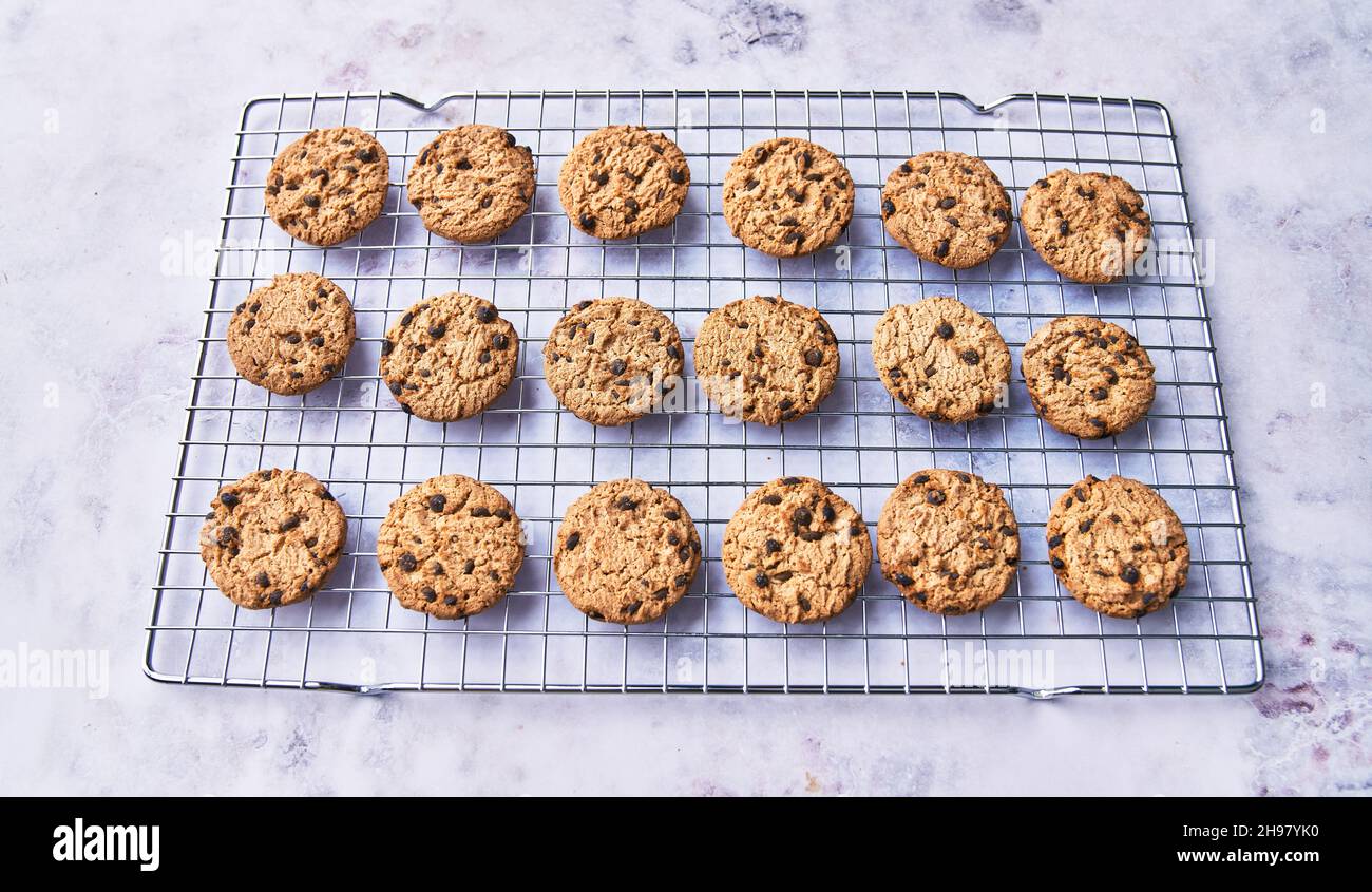 Chocolate cookies served on a grid rack on a marble table Stock Photo ...