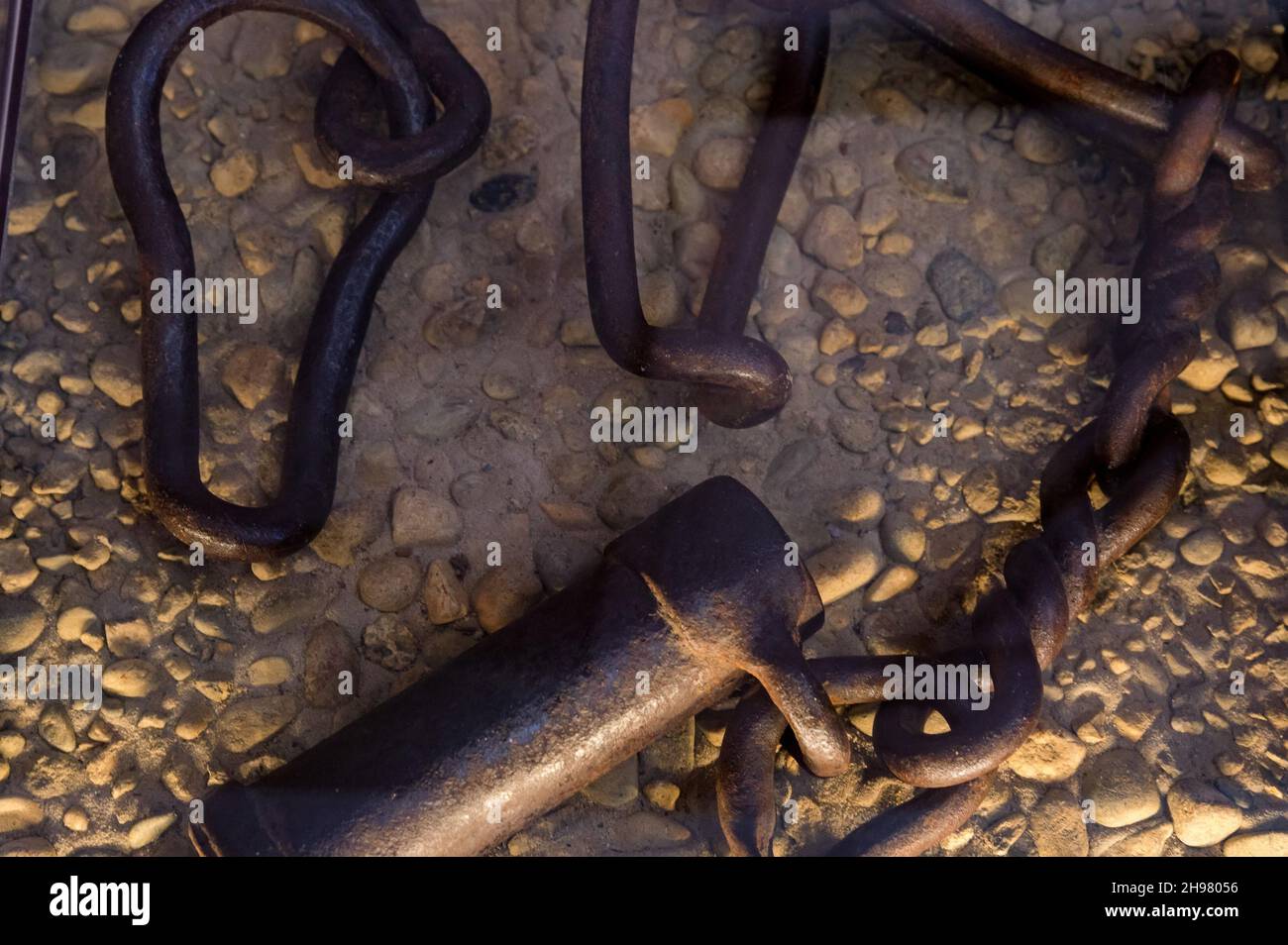 Close-up view of ancient fetters or legcuffs, used on the ankles of a ...