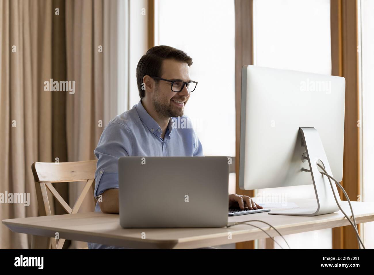 Happy male business professional leader working at workstation monitor ...