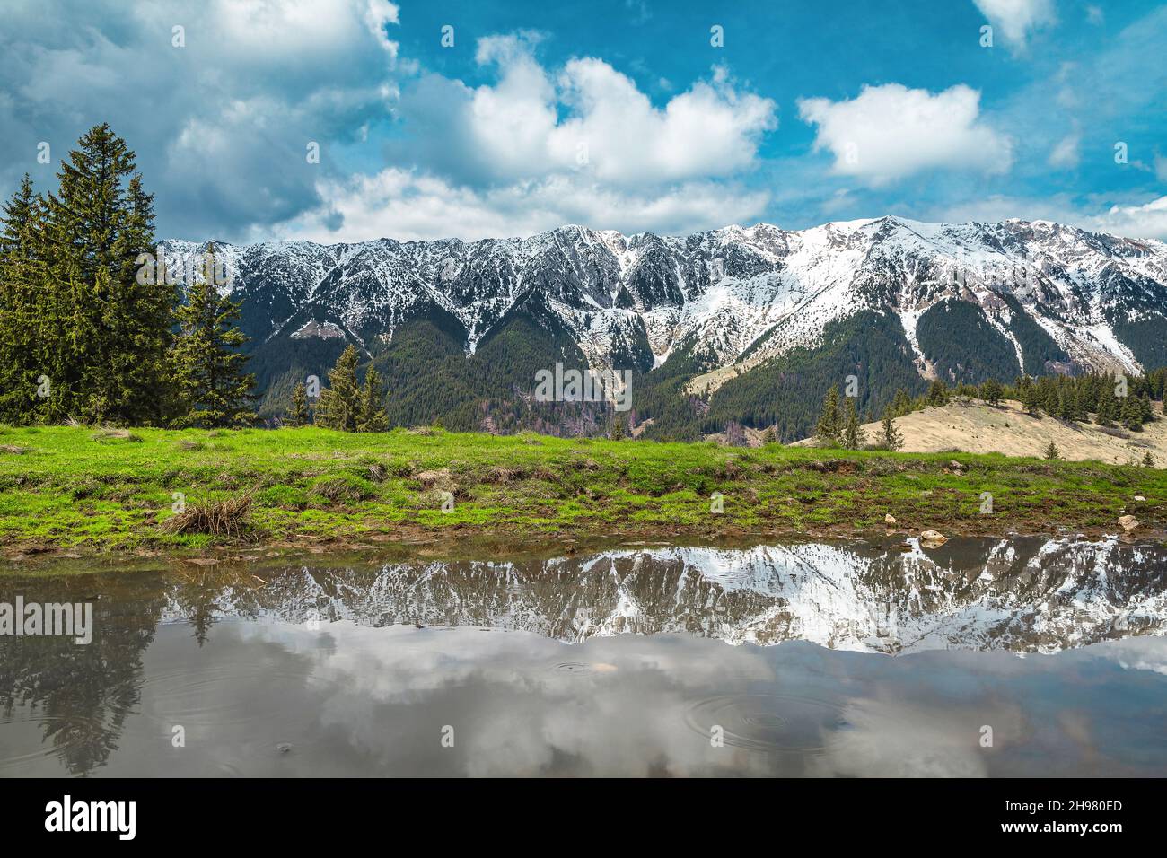 Stunning nature scenery with lake and high snowy Piatra Craiului ...