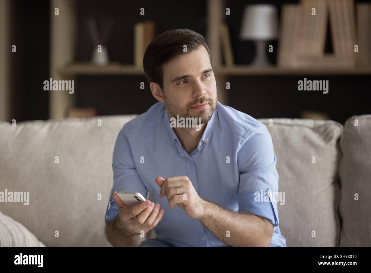 Man using mobile sitting on sofa hi-res stock photography and images ...