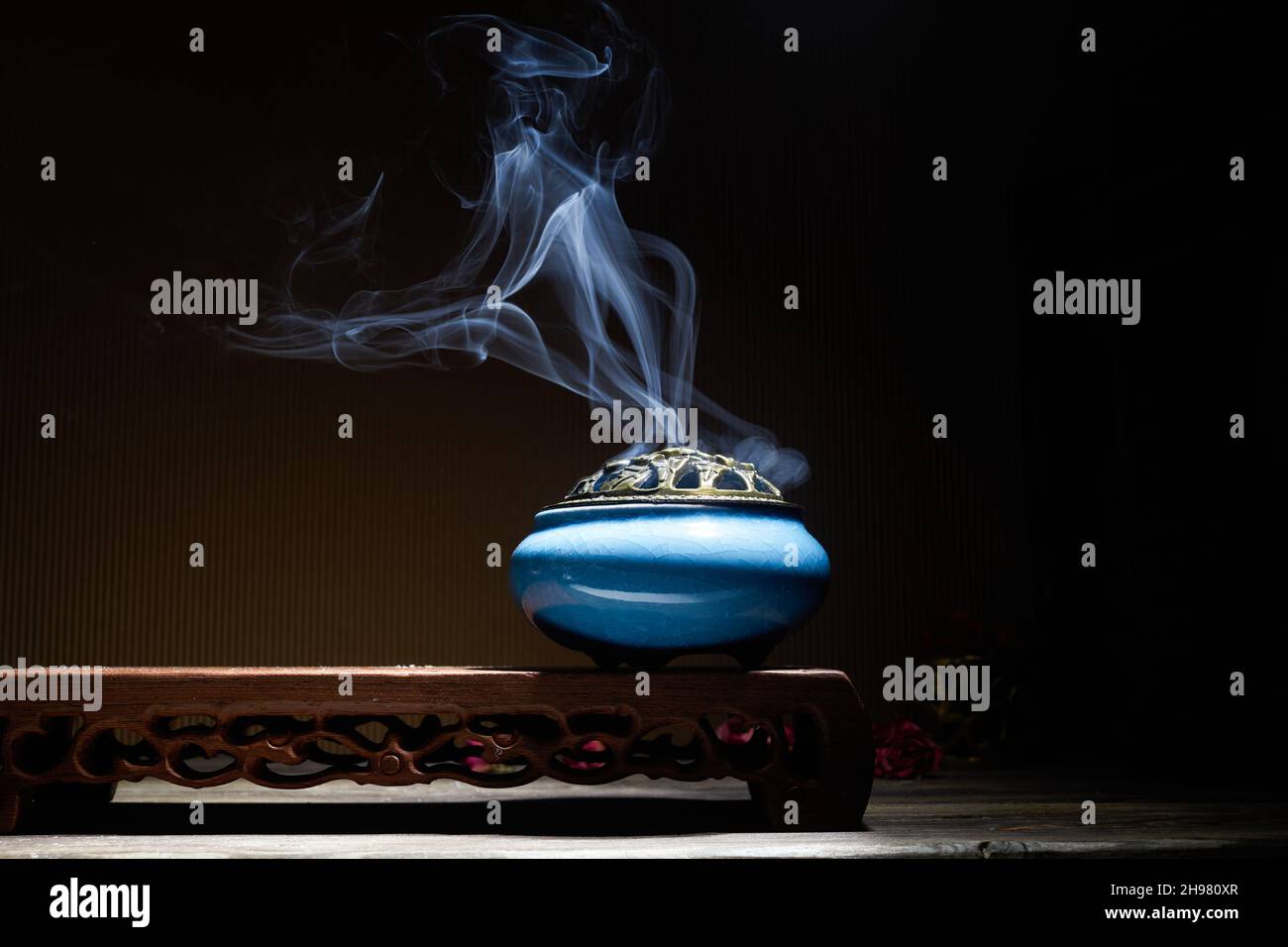 Smoke from burning incense sticks standing on lotus incense holder ...
