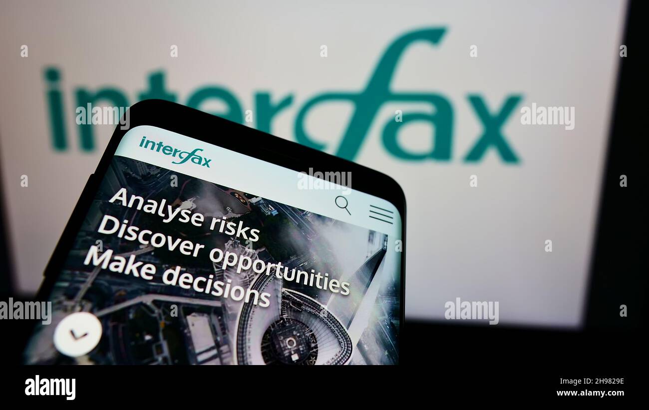 Smartphone with web page of Russian news agency Interfax on screen in ...