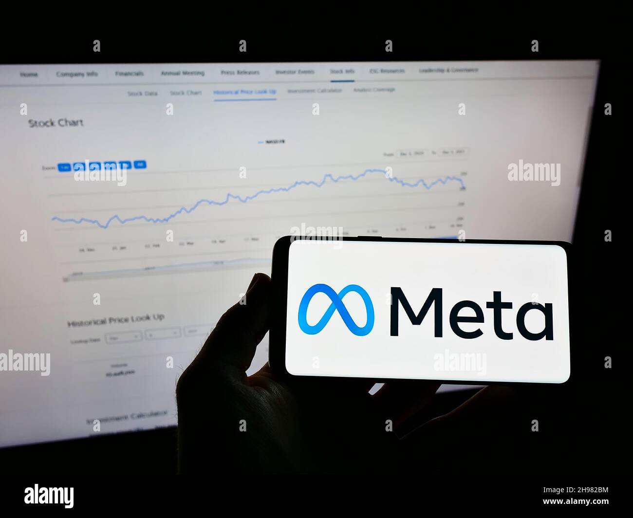Person holding cellphone with logo of American technology company Meta ...