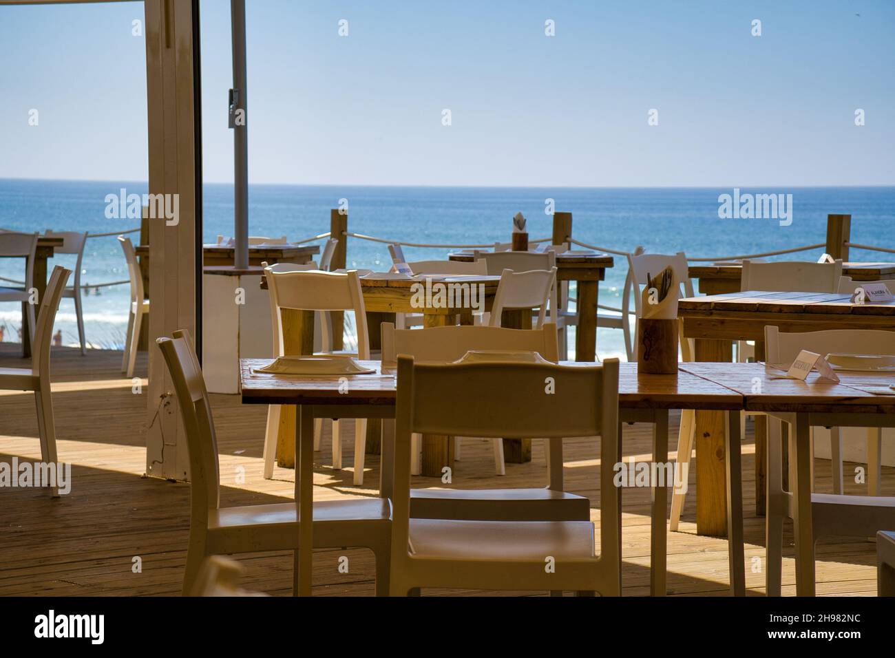 A beautiful view of a cafe with chairs on the beach Stock Photo - Alamy