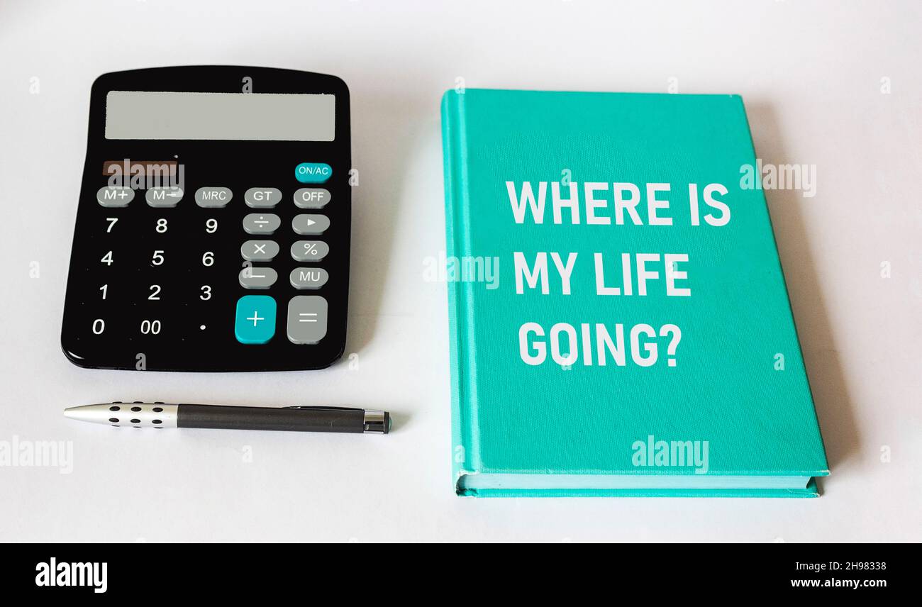 Green diary with letters making the text Where my life going. Conceptual image with calculator ...