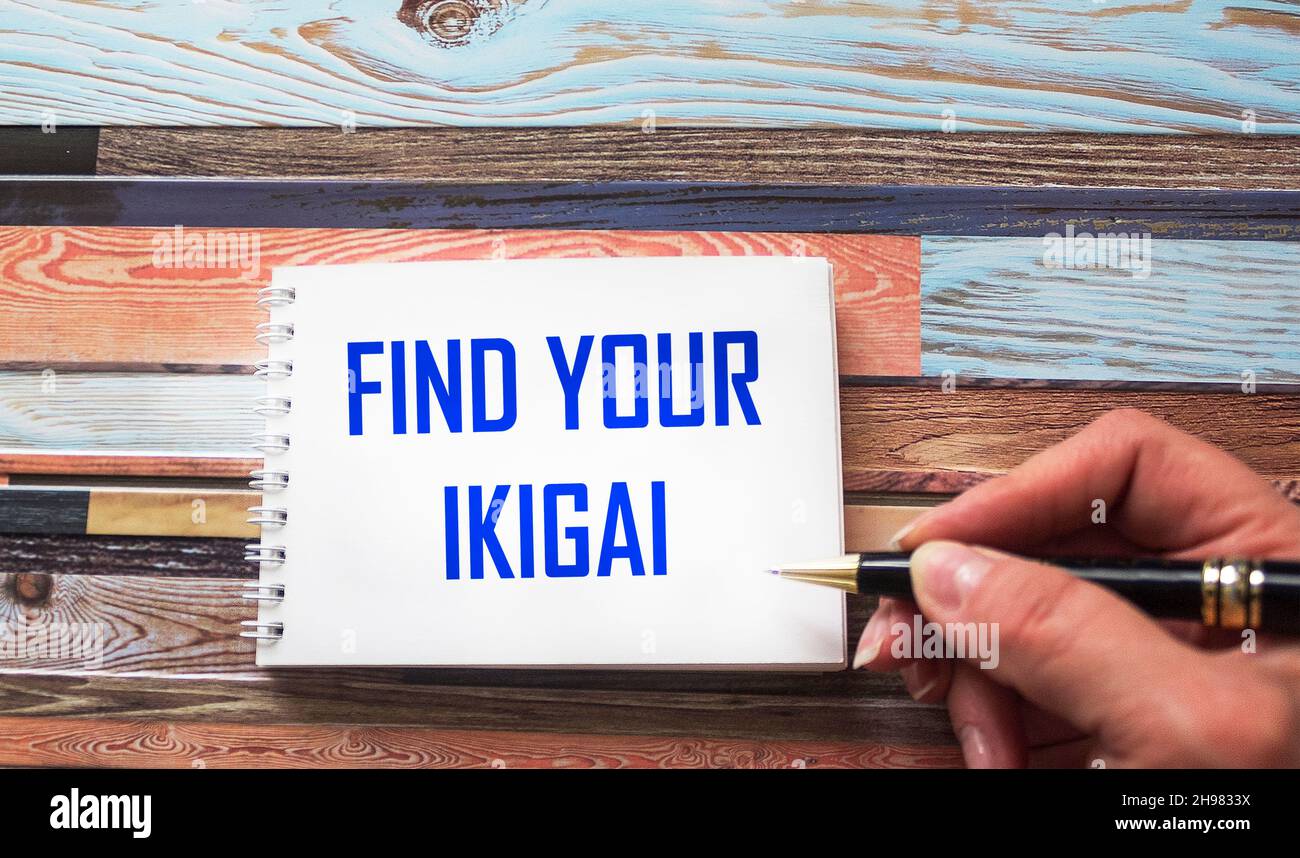 find your ikigai, reminder text is written by a woman's hand in a ...