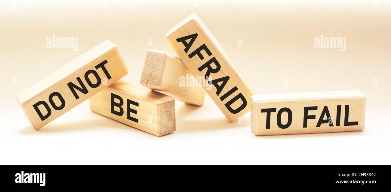 text DO NOT BE AFRAID TO FAIL text on wooden blocks and white ...
