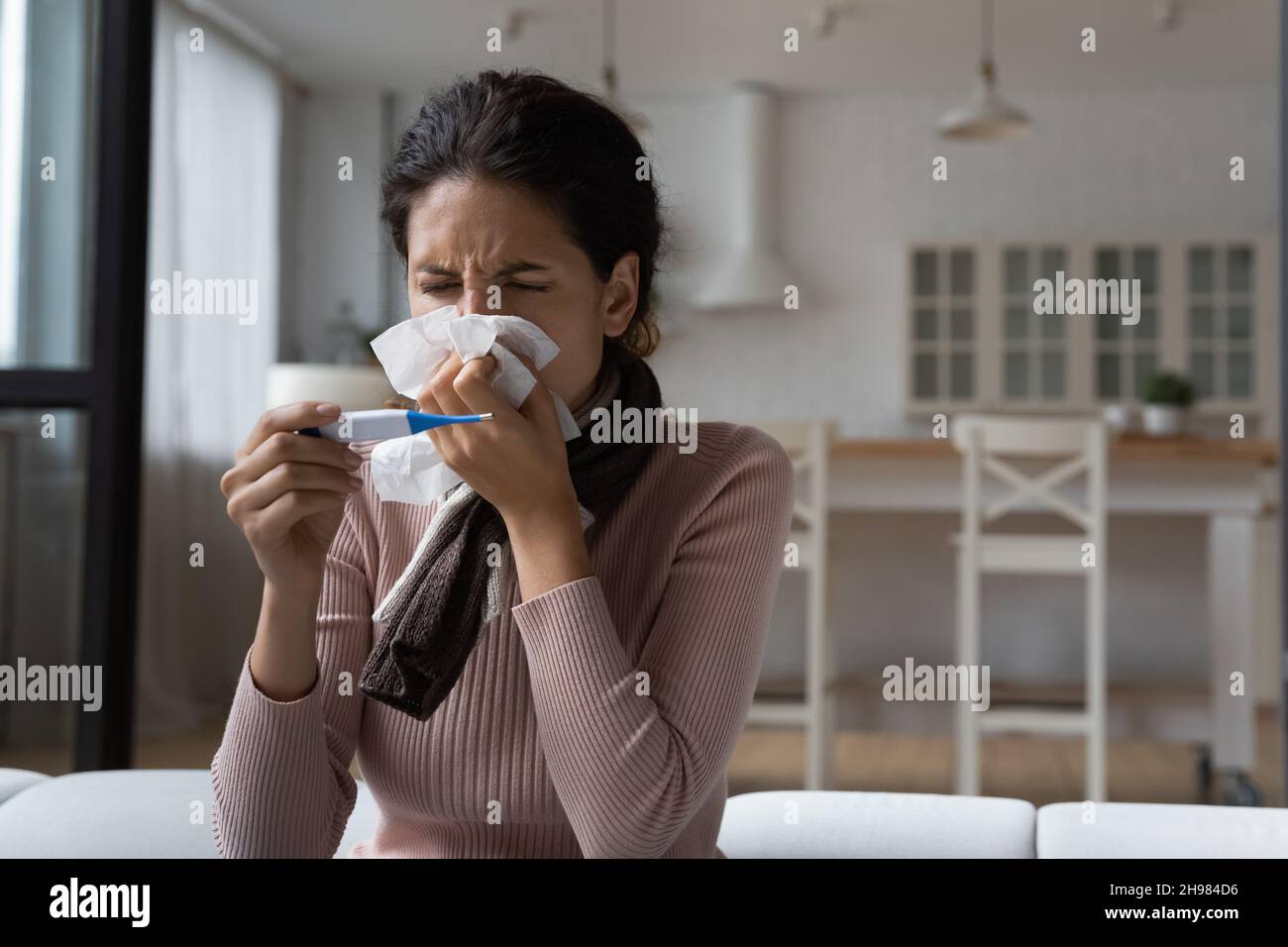 Close up sick woman blowing nose, holding digital thermometer Stock ...
