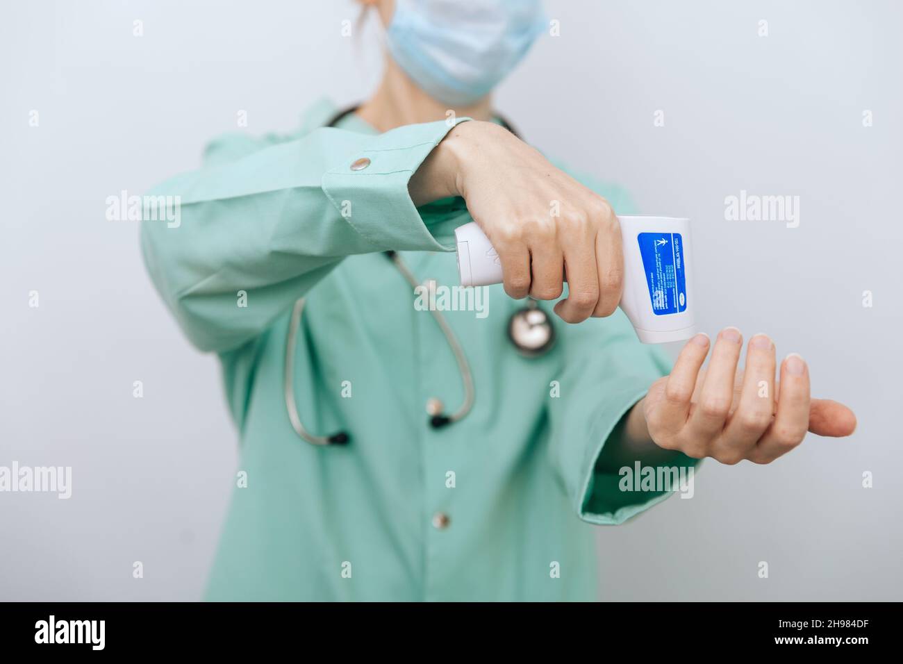 Temperature measurement gun in doctor hands. Close-up shot of doctor ...