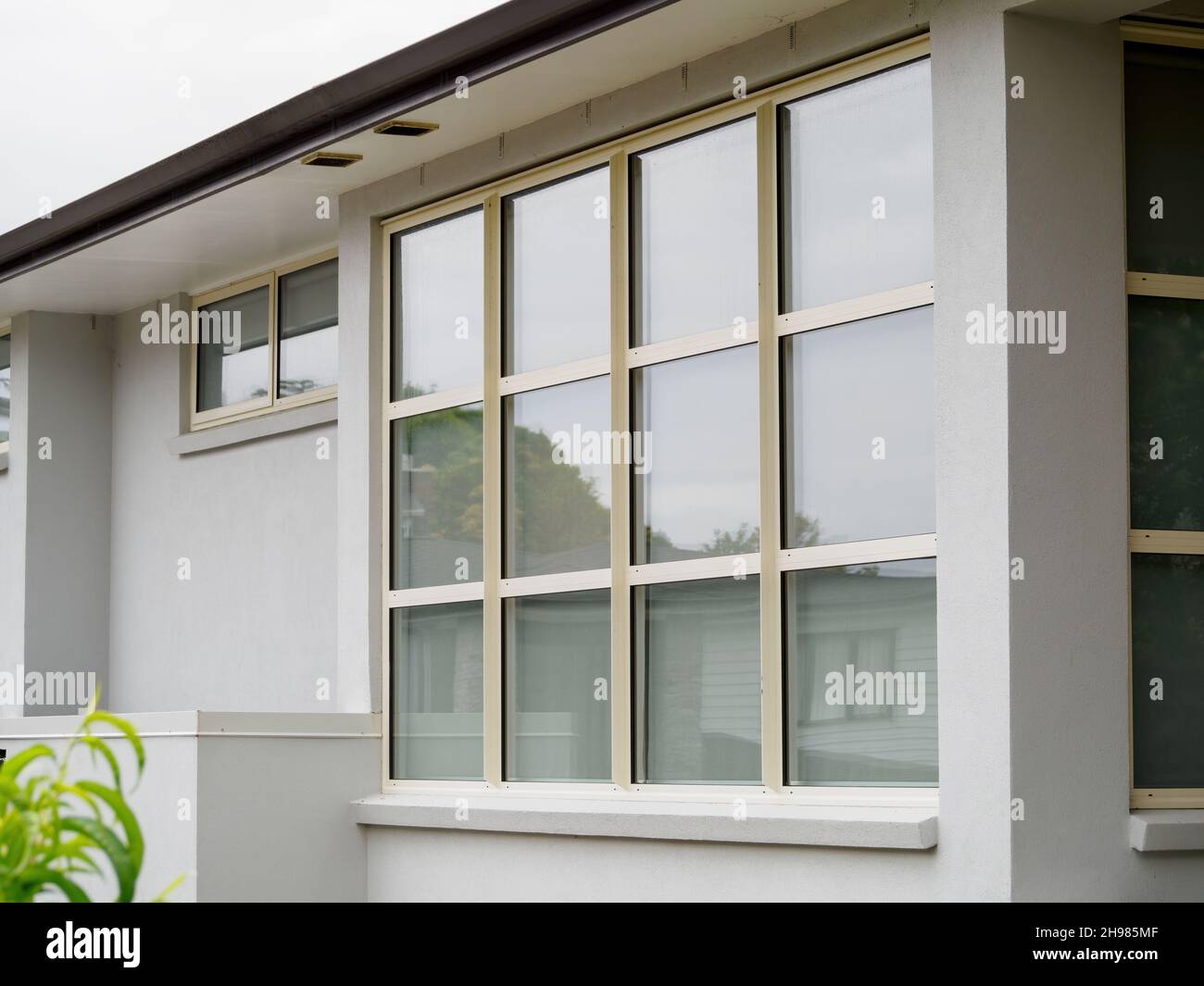 View of divided window with beige aluminum frame Stock Photo - Alamy