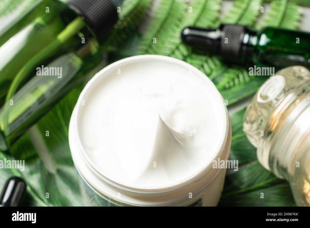 A can of cream is placed on the green background Stock Photo - Alamy