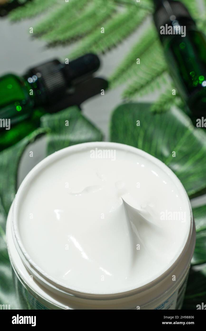 A can of cream is placed on the green background Stock Photo - Alamy