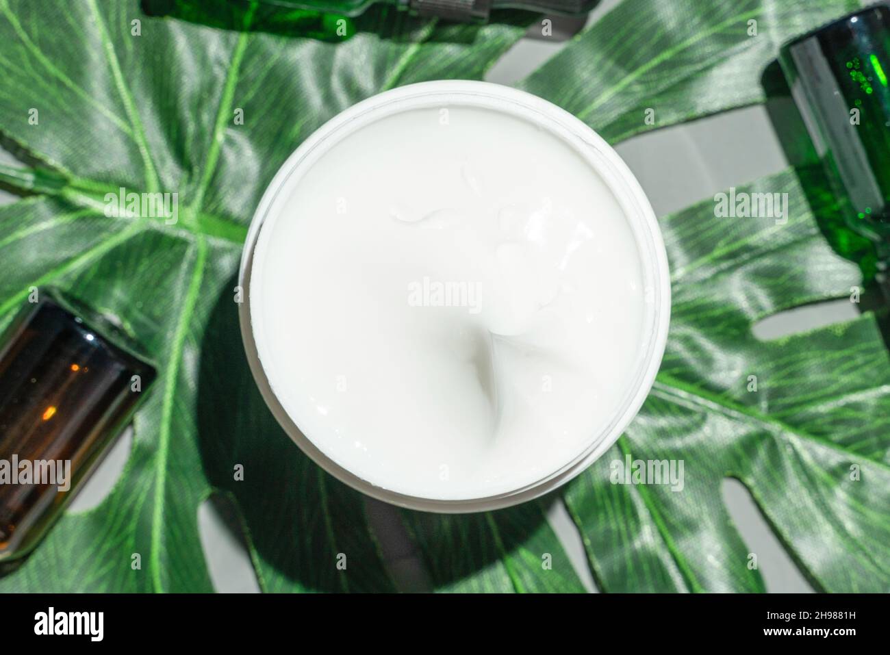 A can of cream is placed on the green background Stock Photo - Alamy