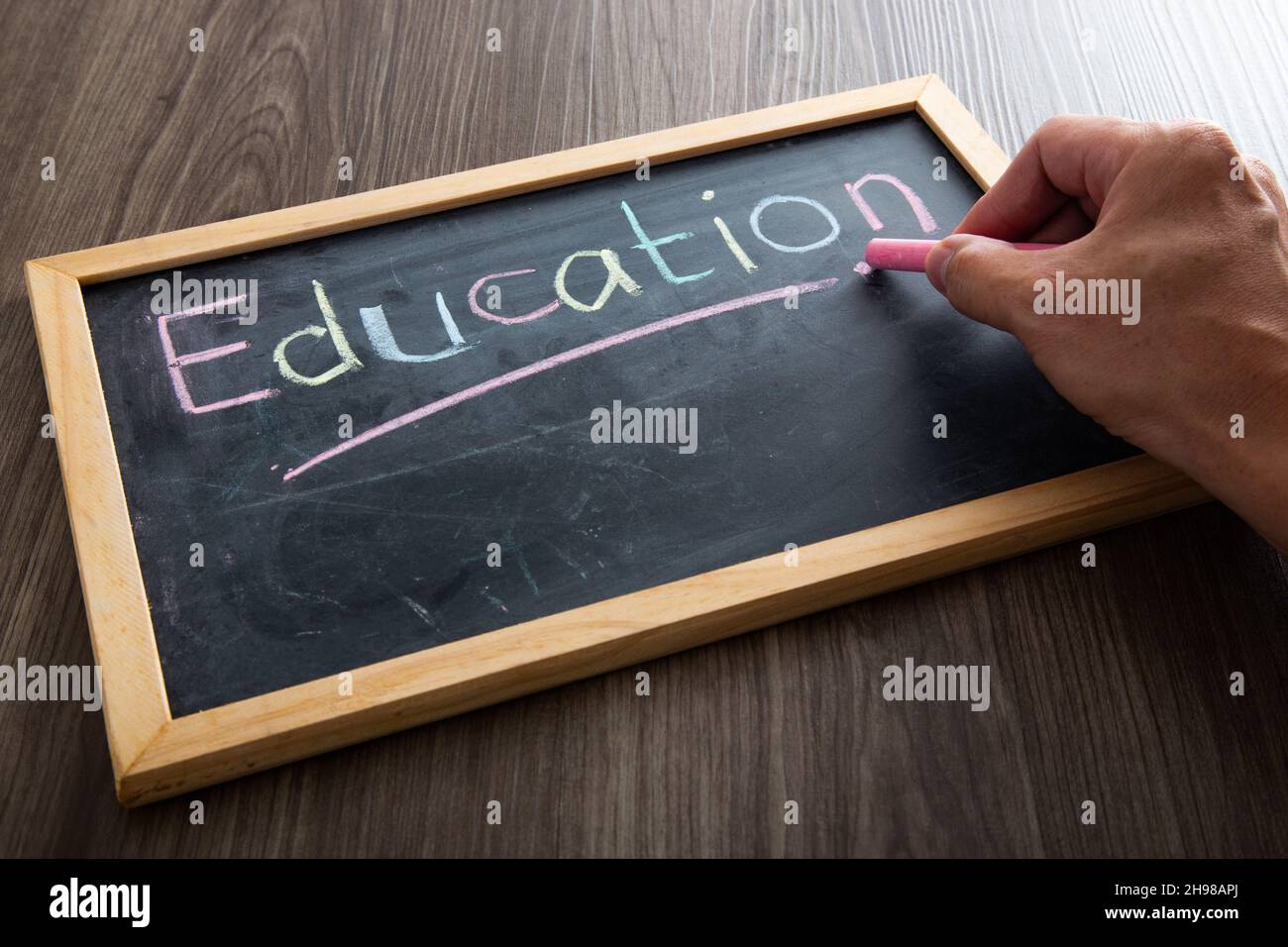 Hand writing word Education written on blackboard. Education Conceptual ...