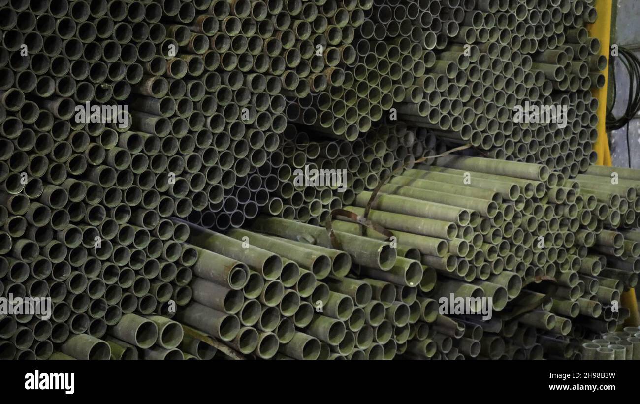Steel pipes are stacked in stock. Industrial pipes used in construction ...